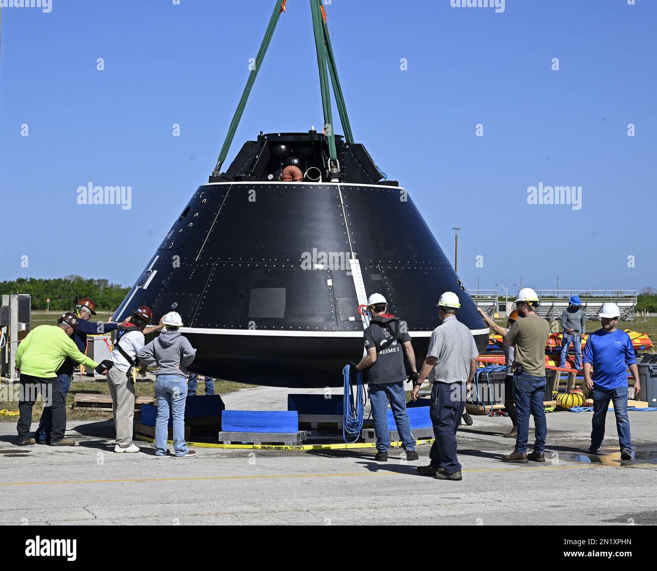 The test article of the Orion spacecraft is lowered onto its cradle ...