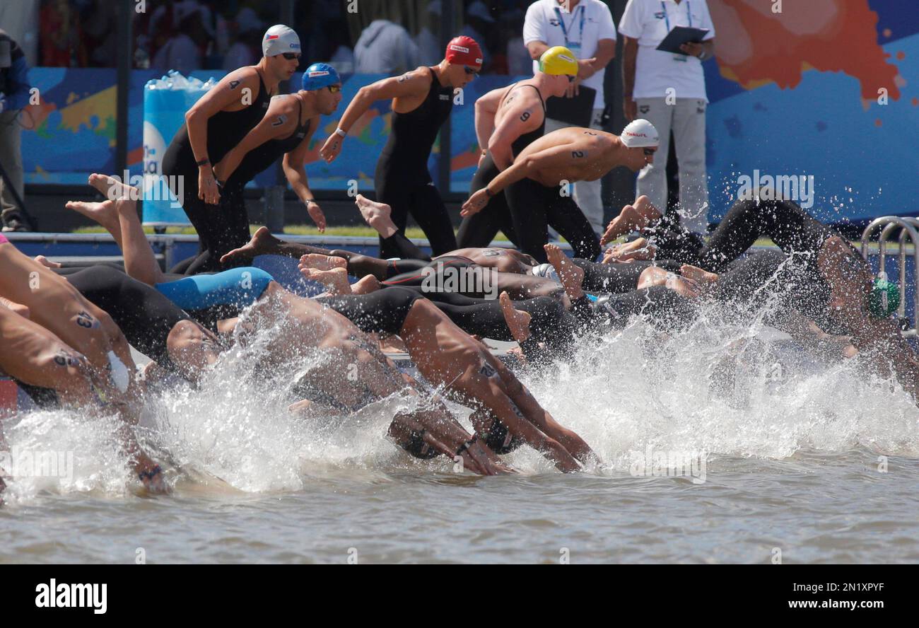 Athletes start the men's 5km open water swim competition at the ...