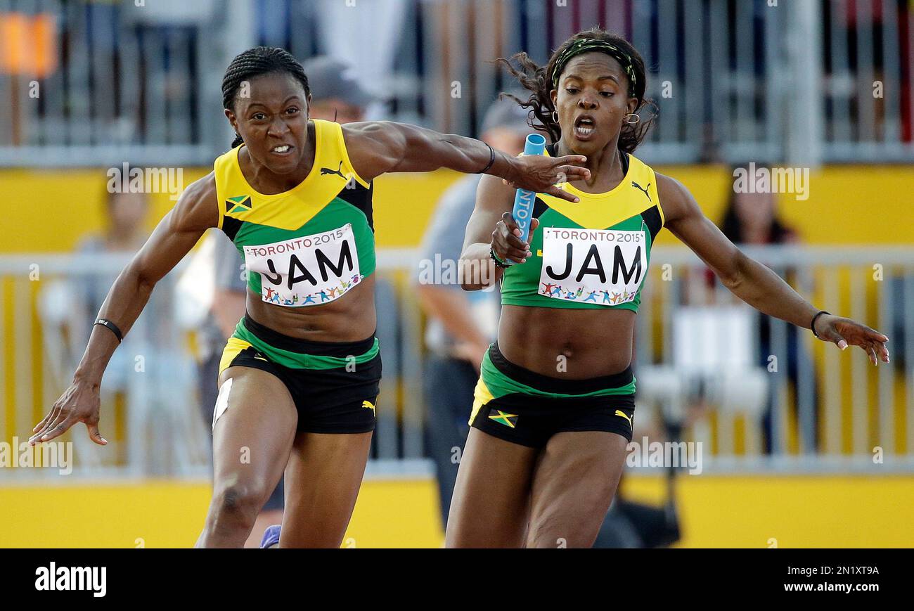 Jamaica's Simone Facey, left, takes the baton from an unidentified ...