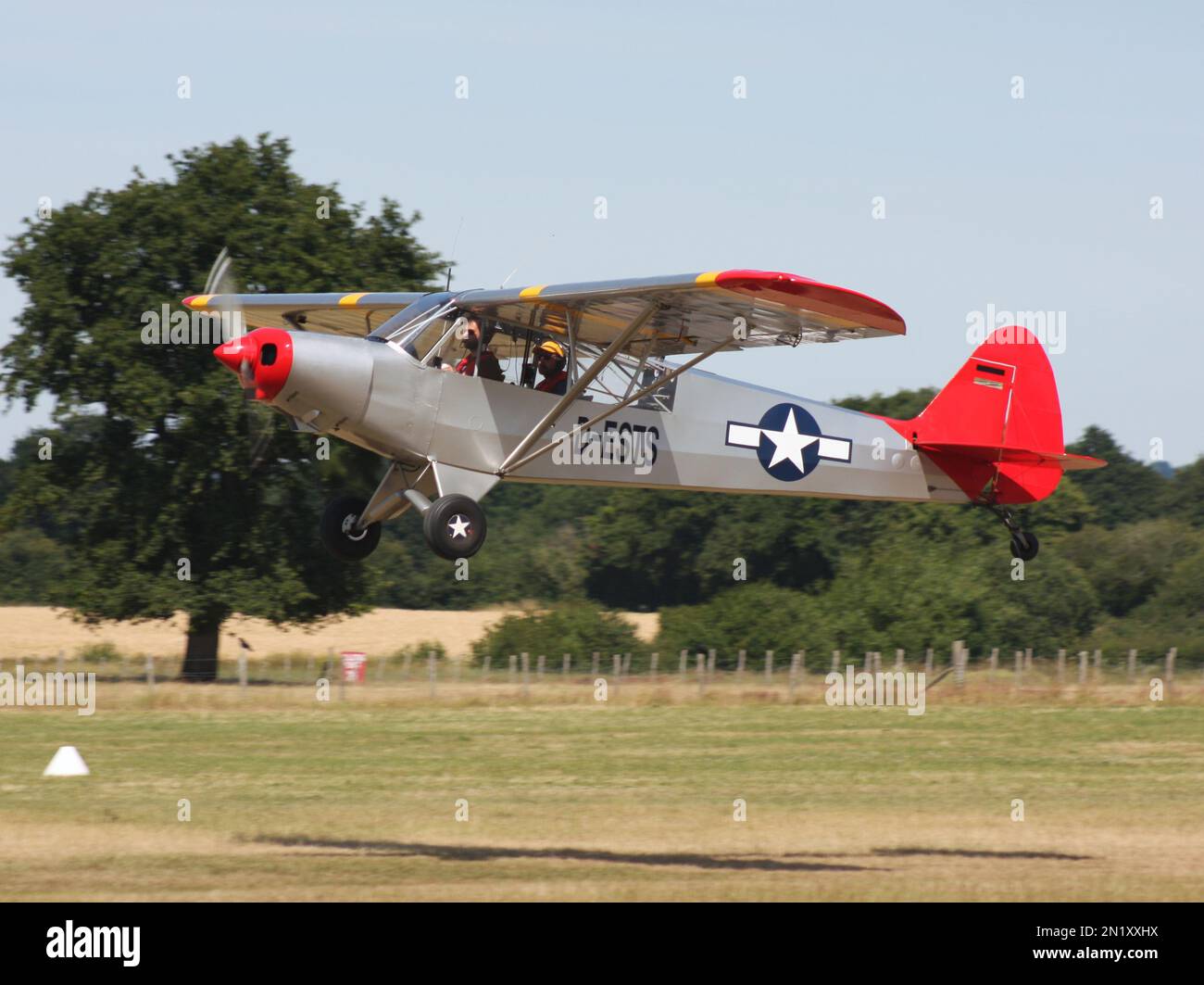 Piper PA-18 Super Cub taking off from Headcorn airfield Kent England ...