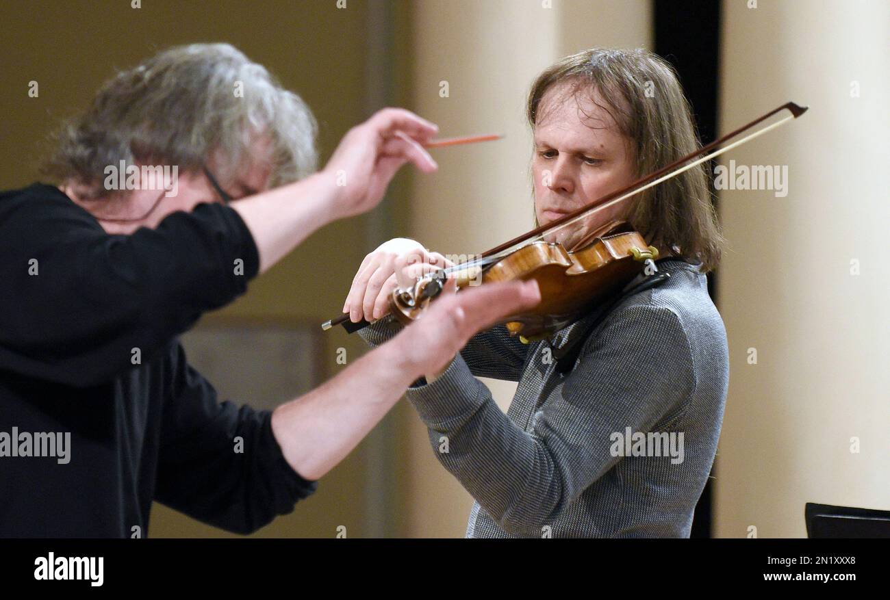 KYIV, UKRAINE - FEBRUARY 6, 2023 - Violin player Dmytro Tkachenko (R) and chief conductor and ...