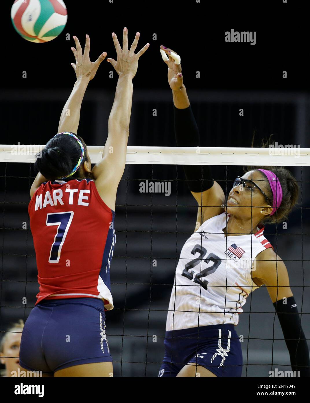 The United States' Rachael Adams, right, spikes past Dominican Republic ...