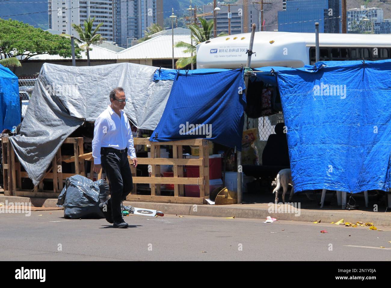 Hawaii Rep. Tom Brower walks through a homeless encampment on Thursday ...