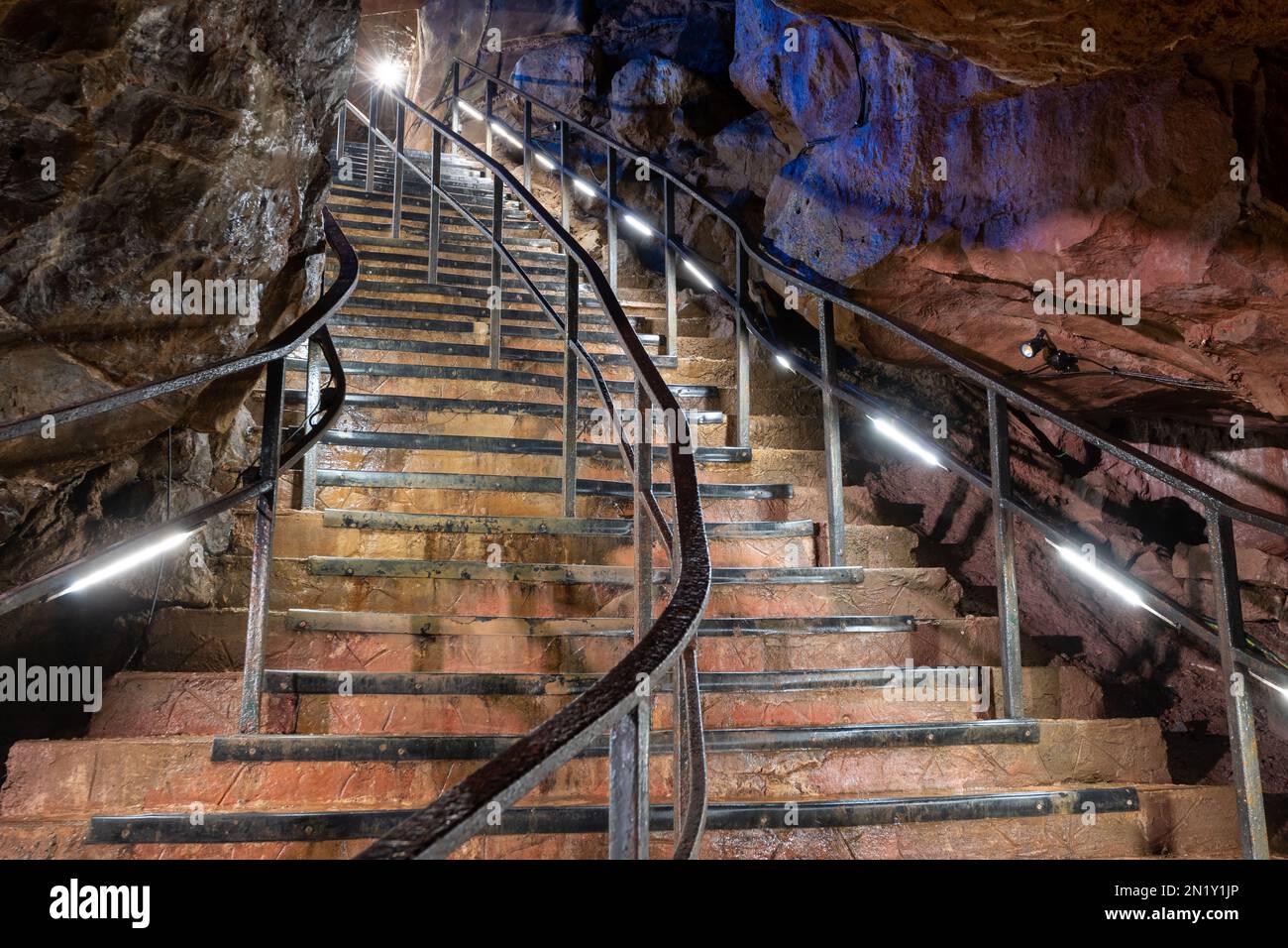 An illuminated staircase inside Goughs Cave in Cheddar in Somerset ...