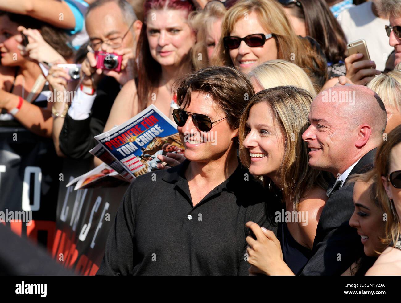 US actor Tom Cruise, center, poses with fans as he arrives for the ...