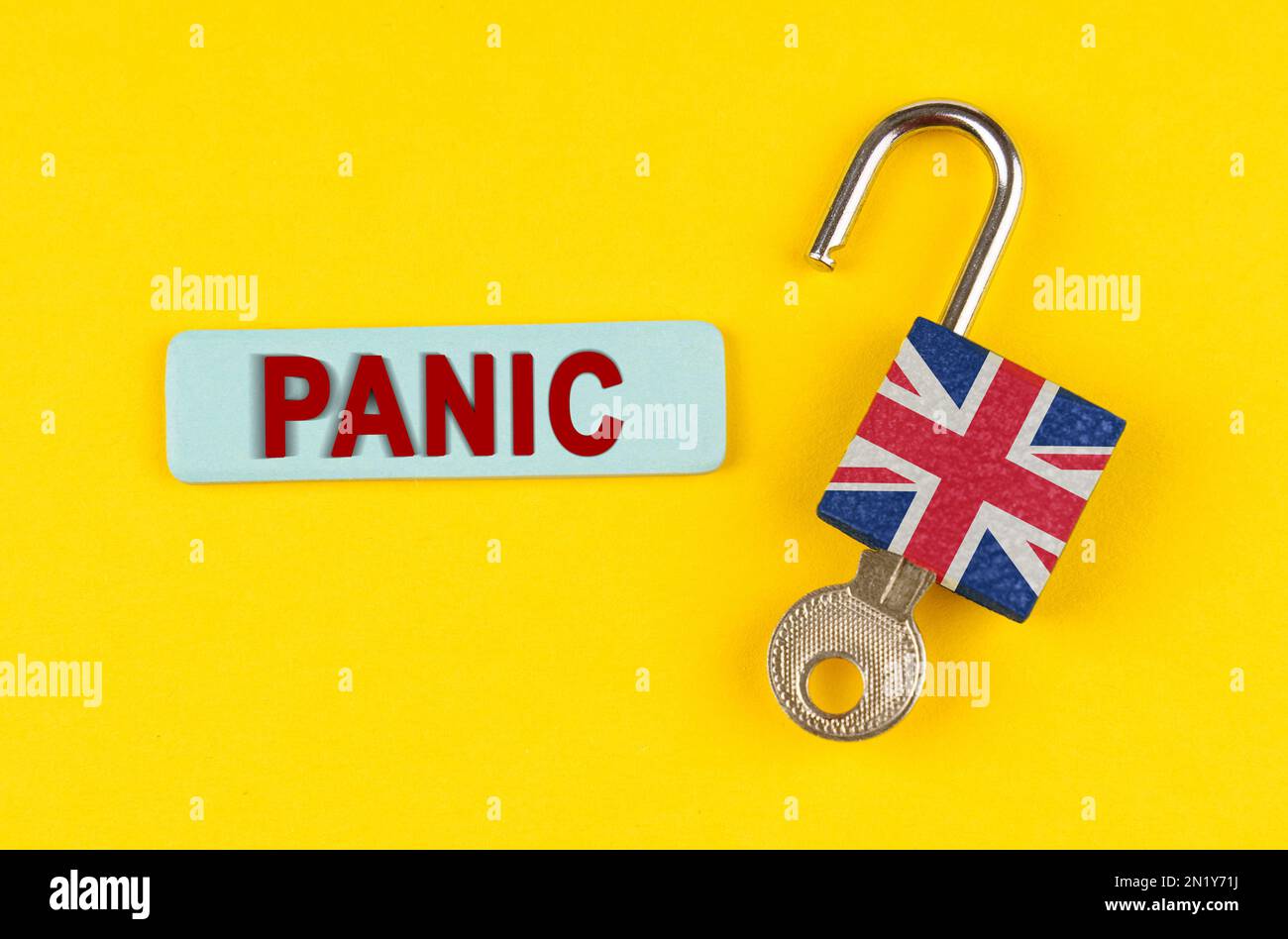 On a yellow surface, an open lock with the image of the flag of Great ...