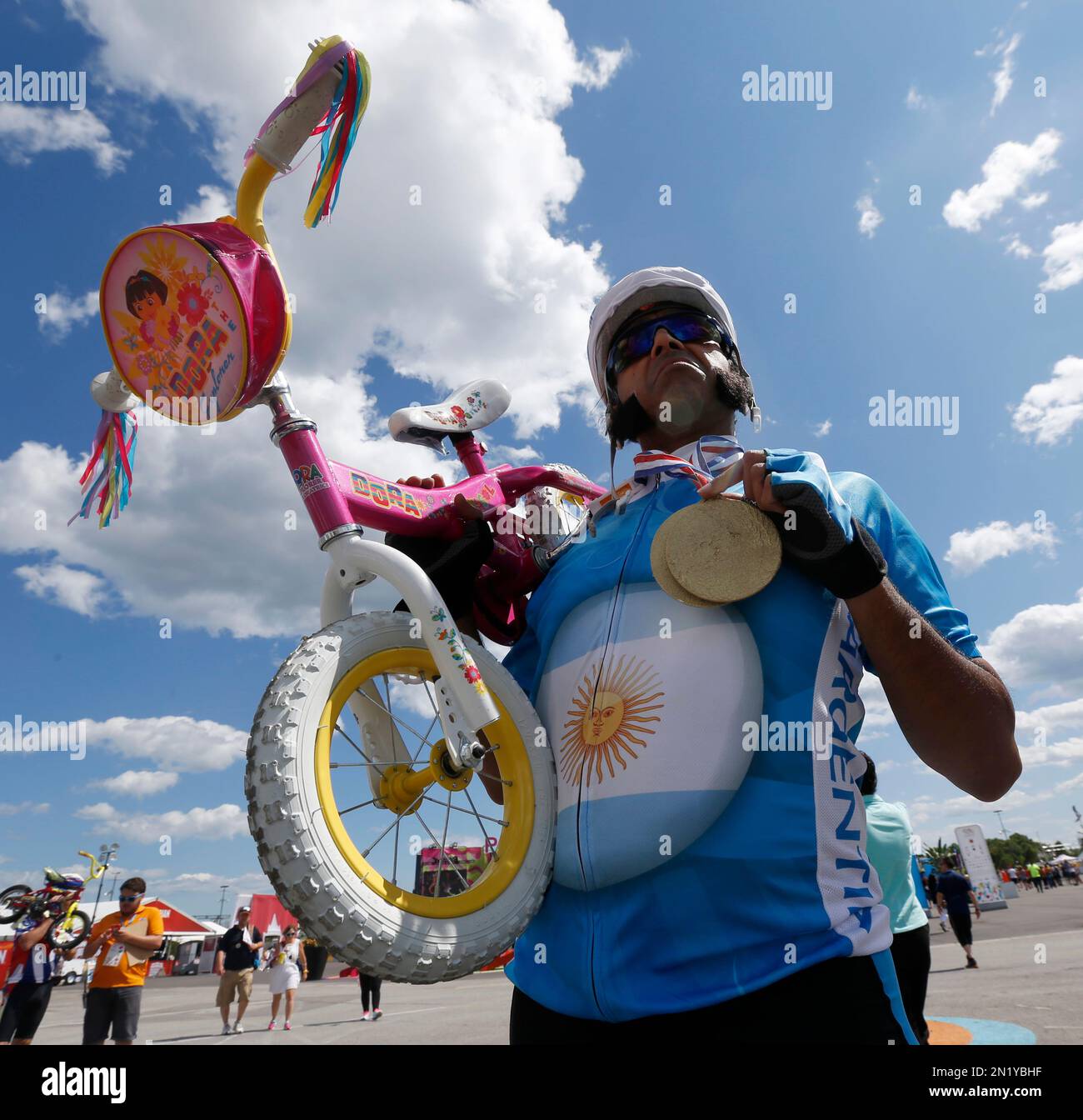 Street performer Anand Rajaram shows off his fake gold medal while ...