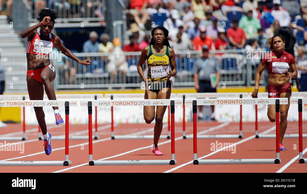 Sparkle McKnight, left, of Trinidad and Tobago, wins her heat in the ...