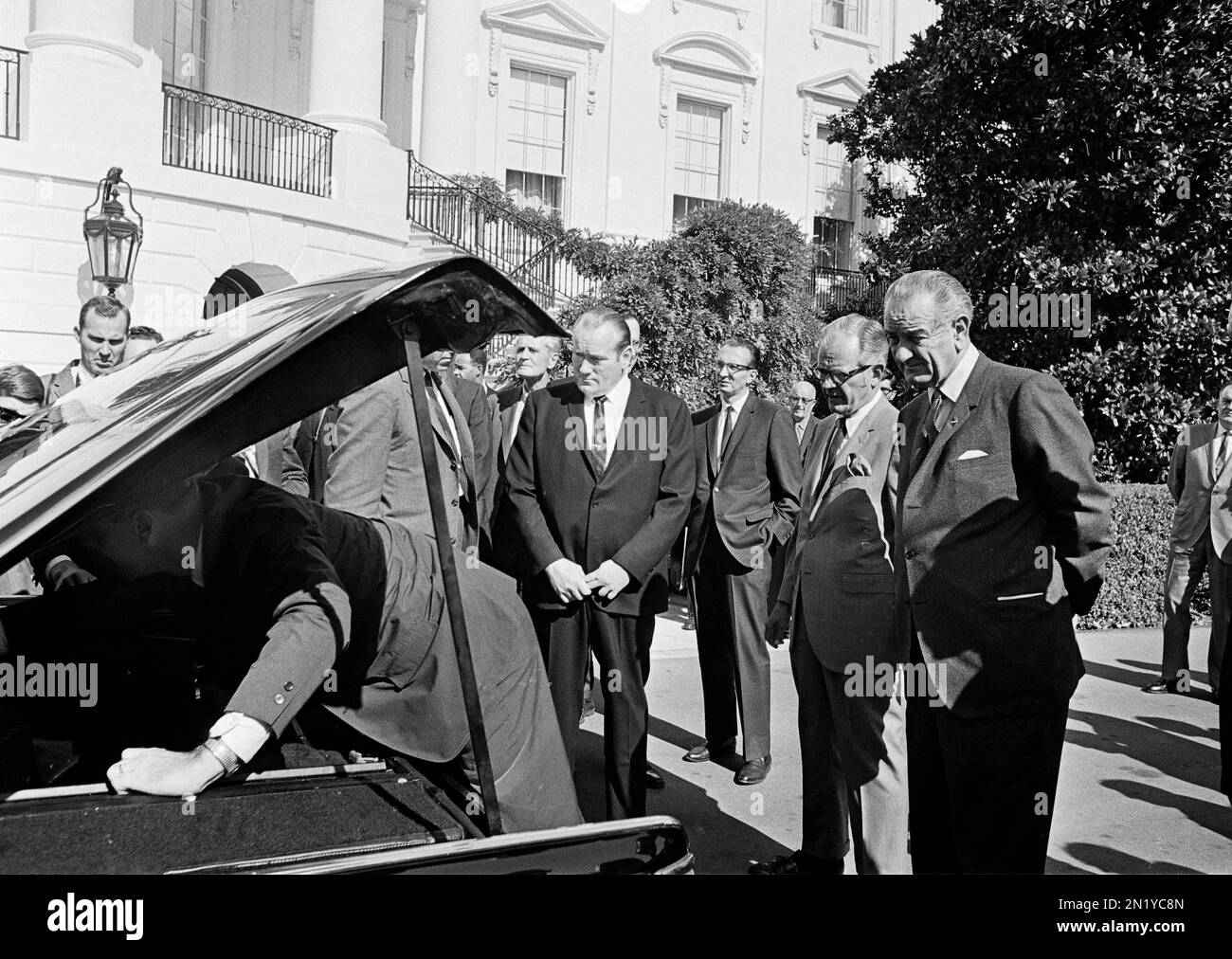 President Lyndon B. Johnson looks on, on the White House grounds at his ...