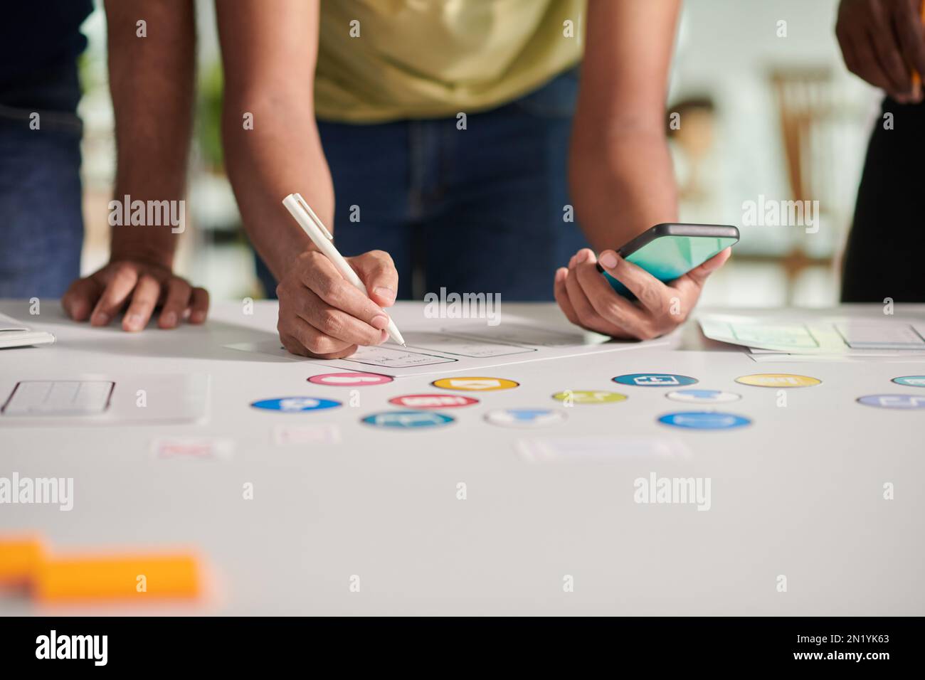UX designer checking message from client on smartphone when correcting ...