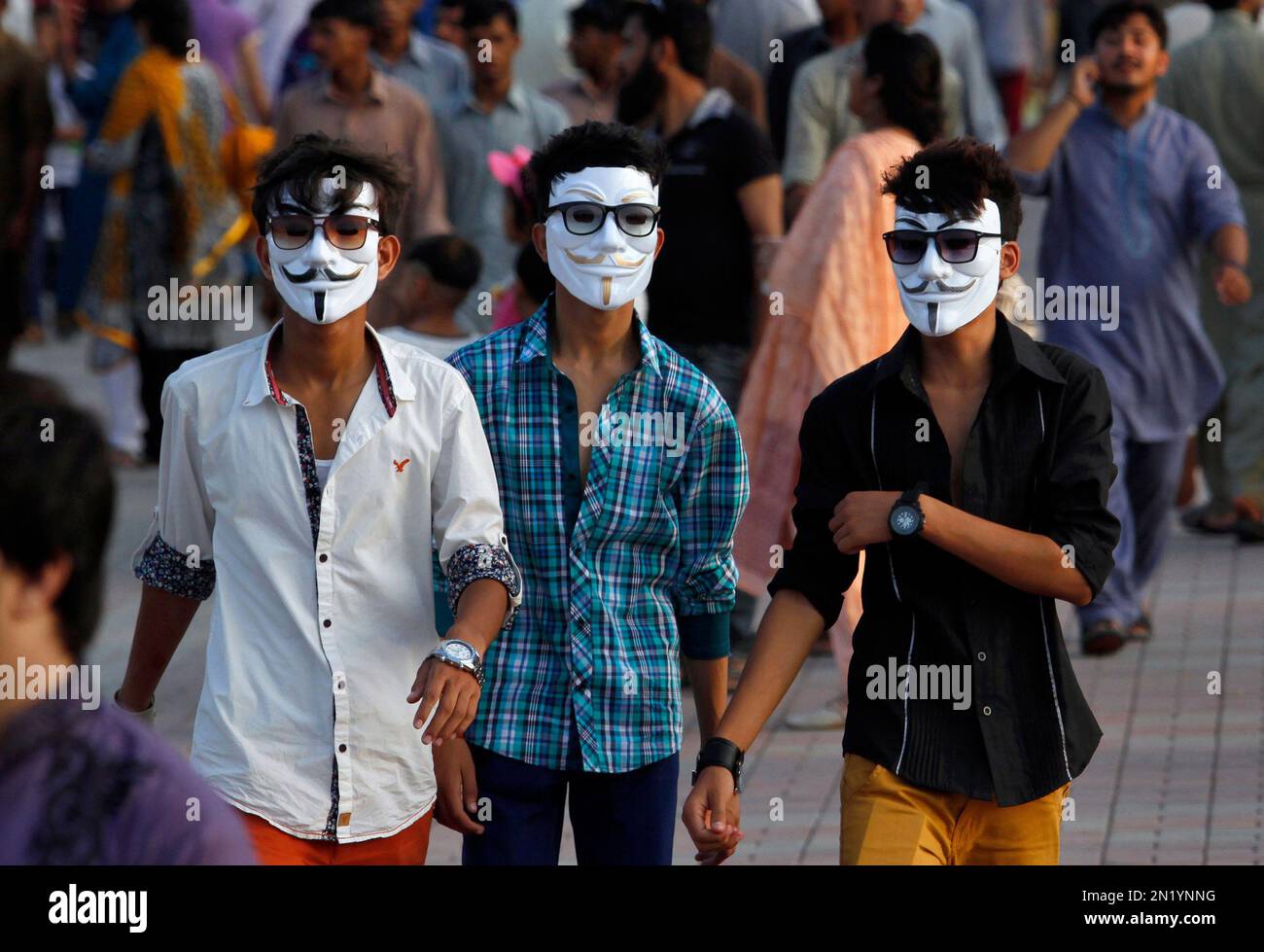 Pakistani youths wear masks as they visit the Lake View picnic area to ...