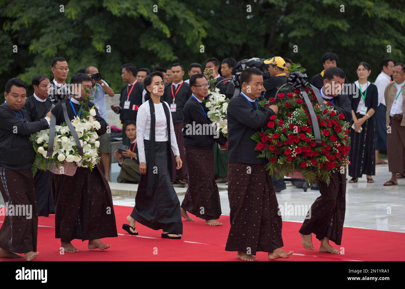 Myanmar opposition leader Aung San Suu Kyi, center in white top ...