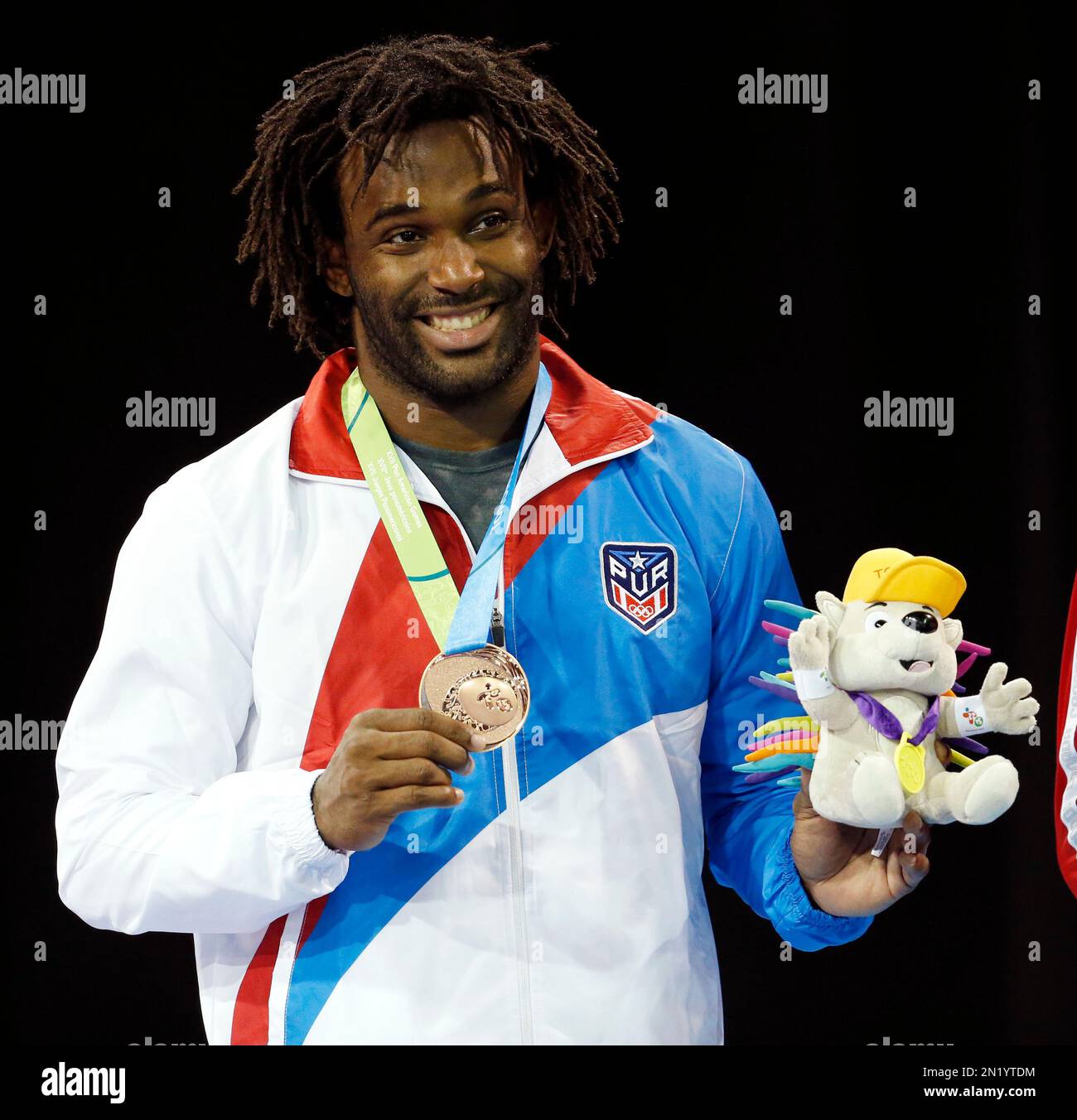 Puerto Rico's Jaime Espinal wears his bronze medal earned in the men's ...