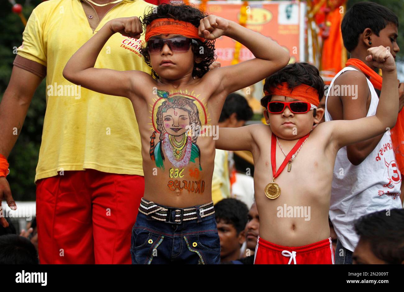 Indian boys display their muscles during the annual Rath Yatra, or ...