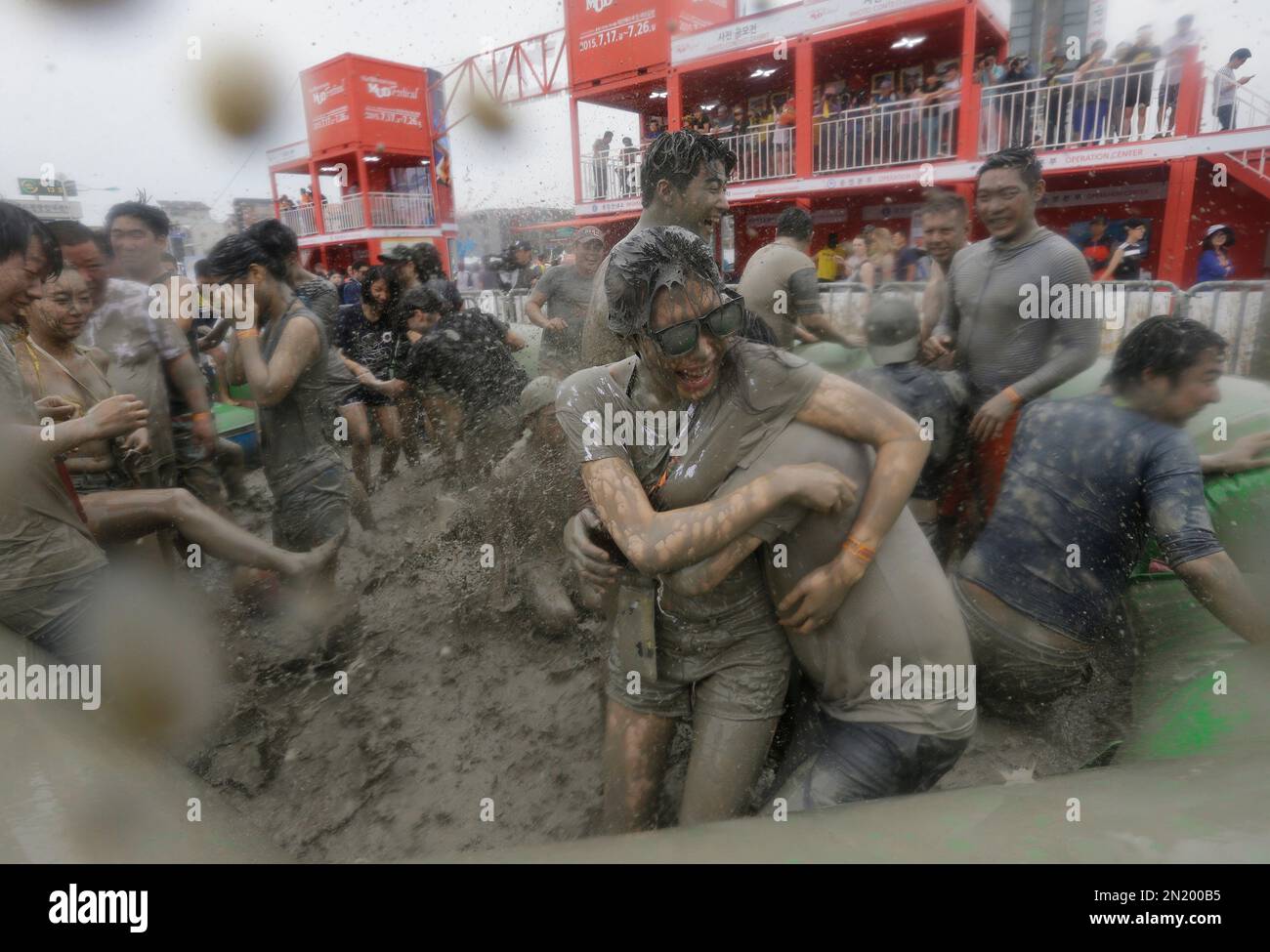 People play in a mud pool during the Boryeong Mud Festival at Daecheon ...
