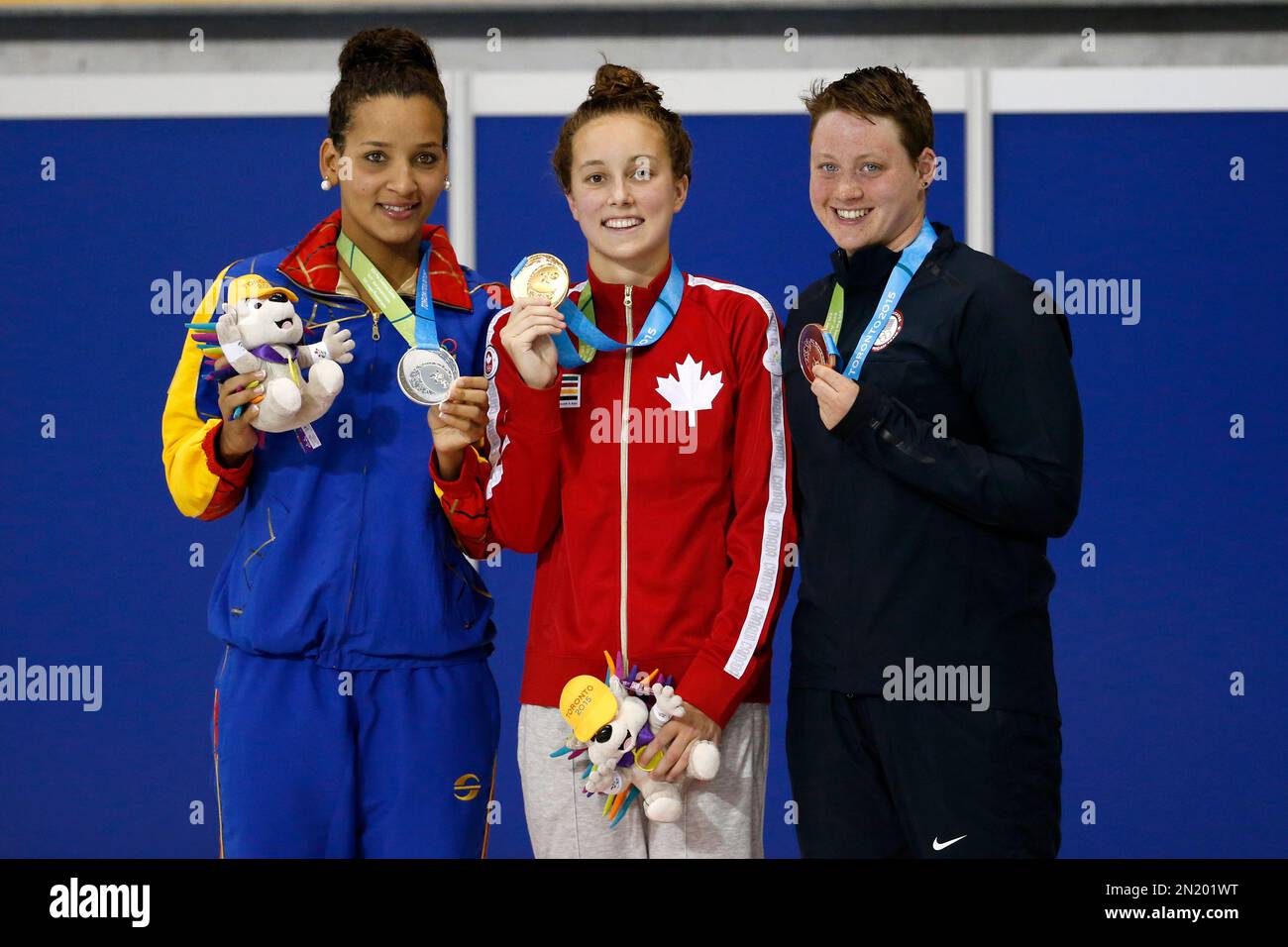 Gold medalist Emily Overholt, center, of Canada, poses for ...