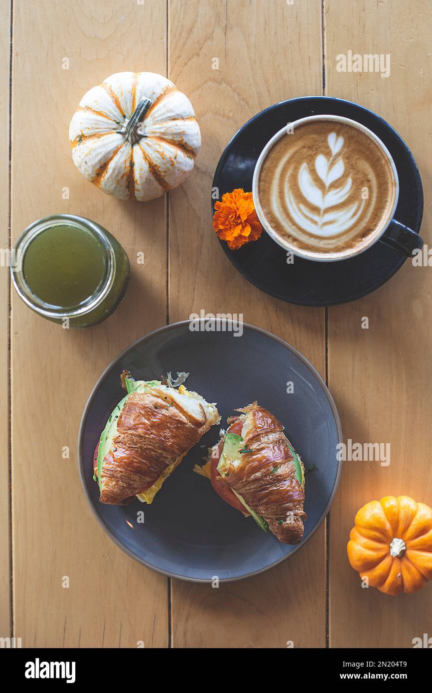 Table full of food and coffee prepared by a barista in a black cup on a ...