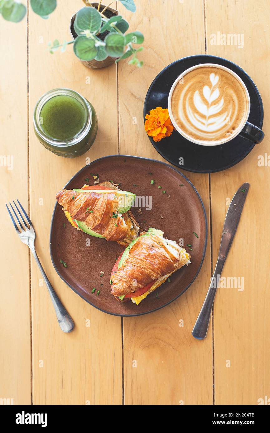 Table full of food and coffee prepared by a barista in a black cup on a ...