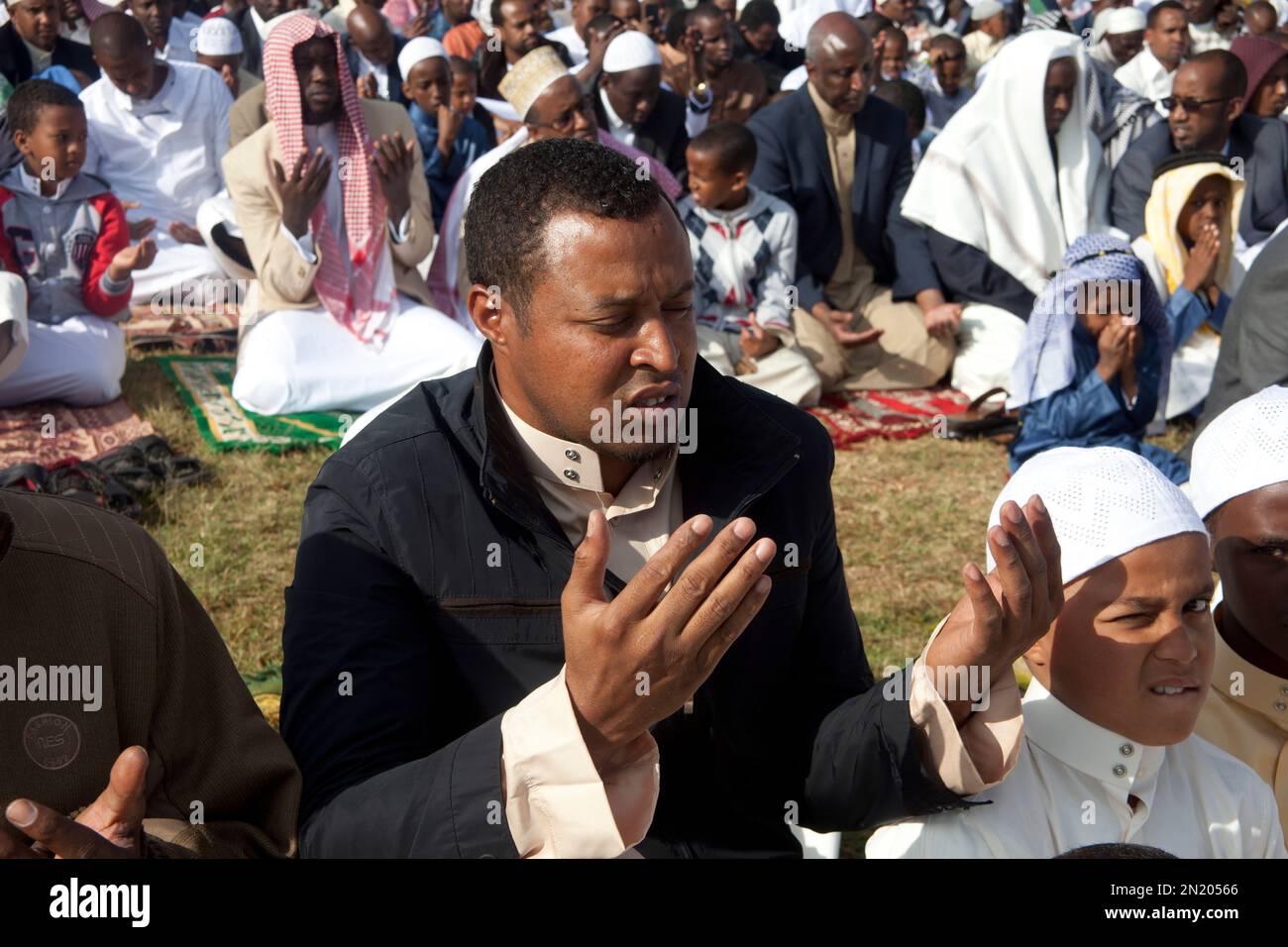 A Kenyan Muslim raises his hands as he joins hundreds of others to ...