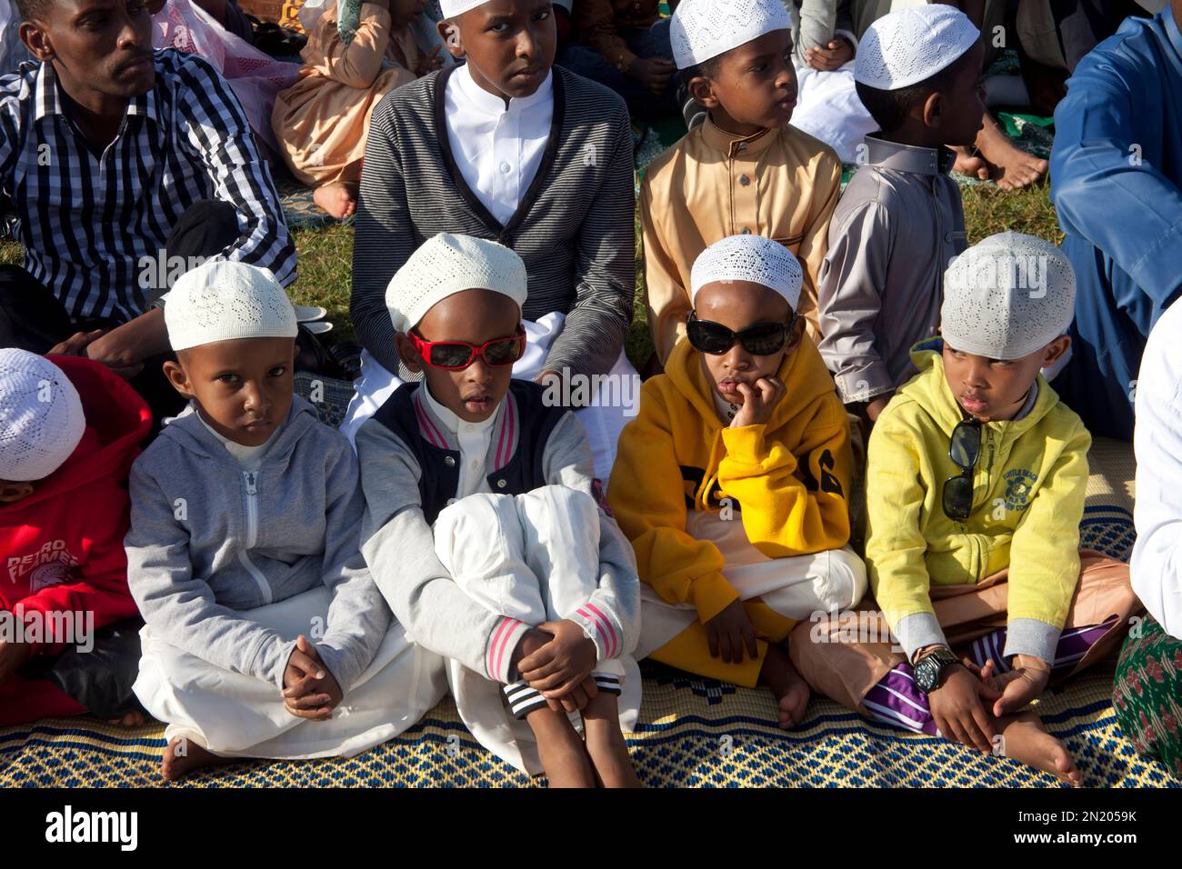 Kenyan Muslim children join hundred of Muslims at an open ground in ...