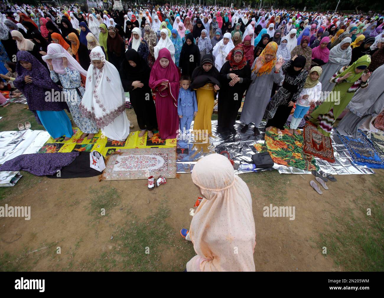 Filipino Muslims pray as they gather at Manila's Rizal Park to mark the ...