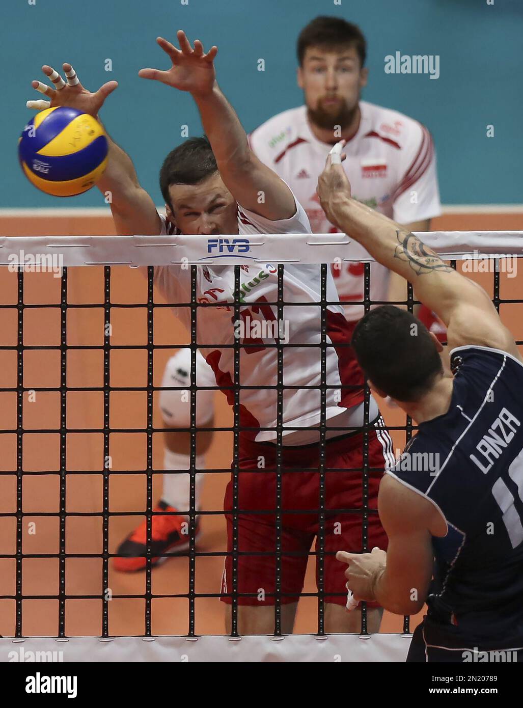Poland's Rafal Buszek jumps to block the spiked ball of Italy's Filippo ...