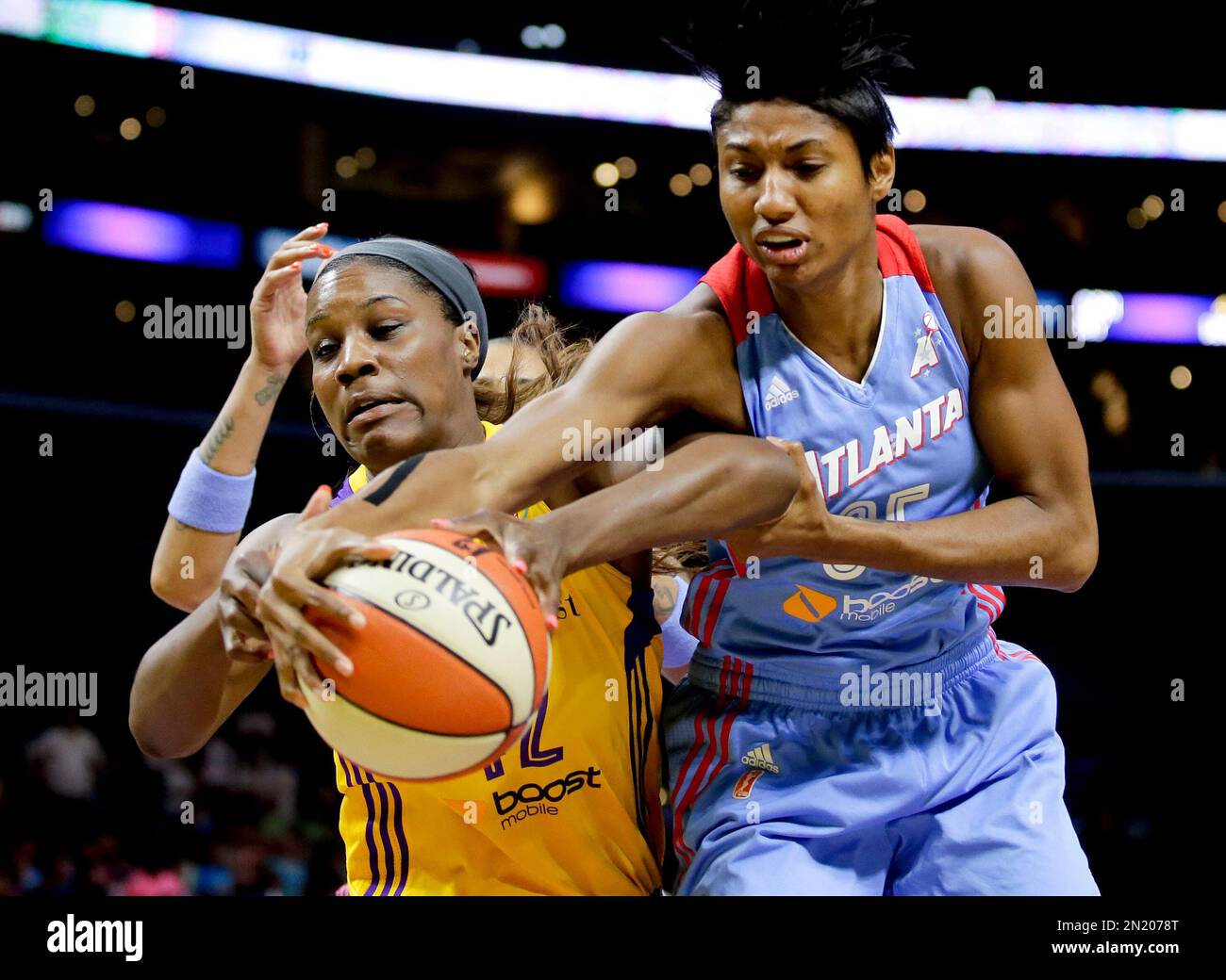 Atlanta Dream's Angel McCoughtry, right, blocks a shot by Los Angeles ...