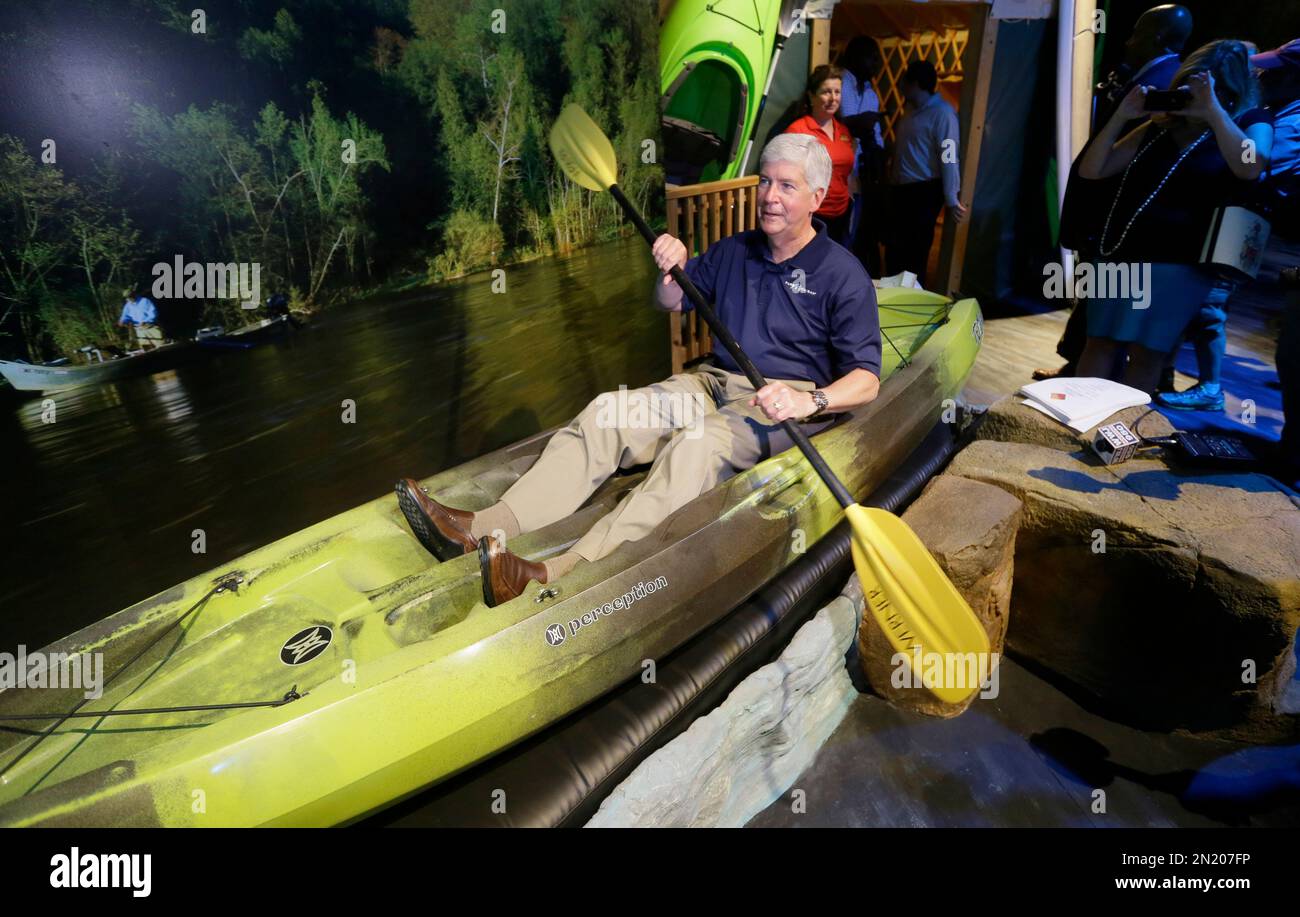 Michigan Gov. Rick Snyder tests a kayak simulator at the opening of the ...