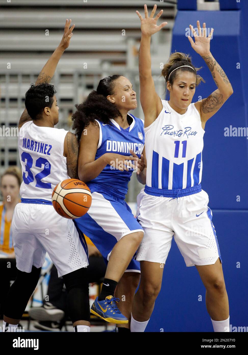 Carmen Guzman, center, of the Dominican Republic, loses the ball as she ...