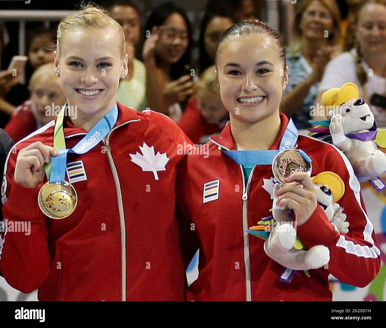 Canada's Ellie Black, left, poses wearing her gold medal alongside ...