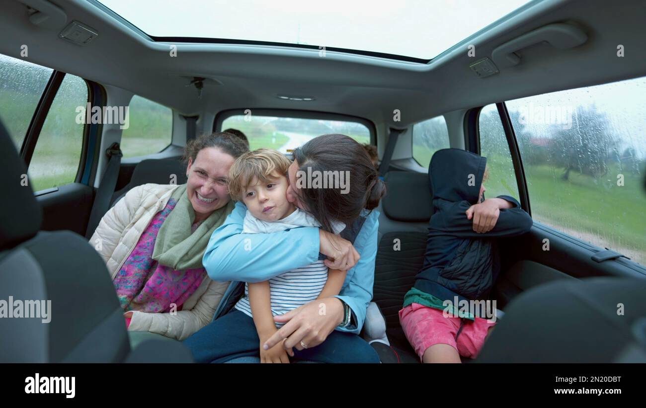 Happy people inside car backseat waving hands laughing and smiling ...