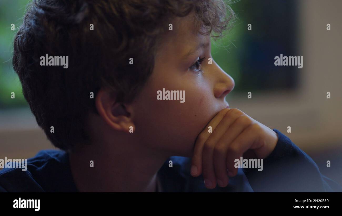 One thoughtful young boy candid kid thinking contemplative child Stock ...