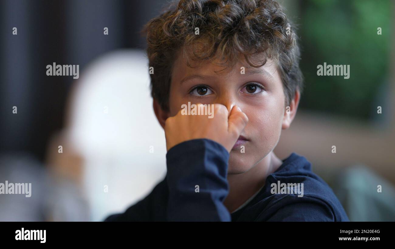 One thoughtful young boy thinking portrait pensive contemplative child ...