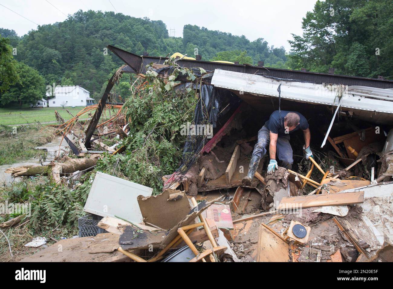 Roland Marcum looks for his brother-in-law Scott Johnson under the ...