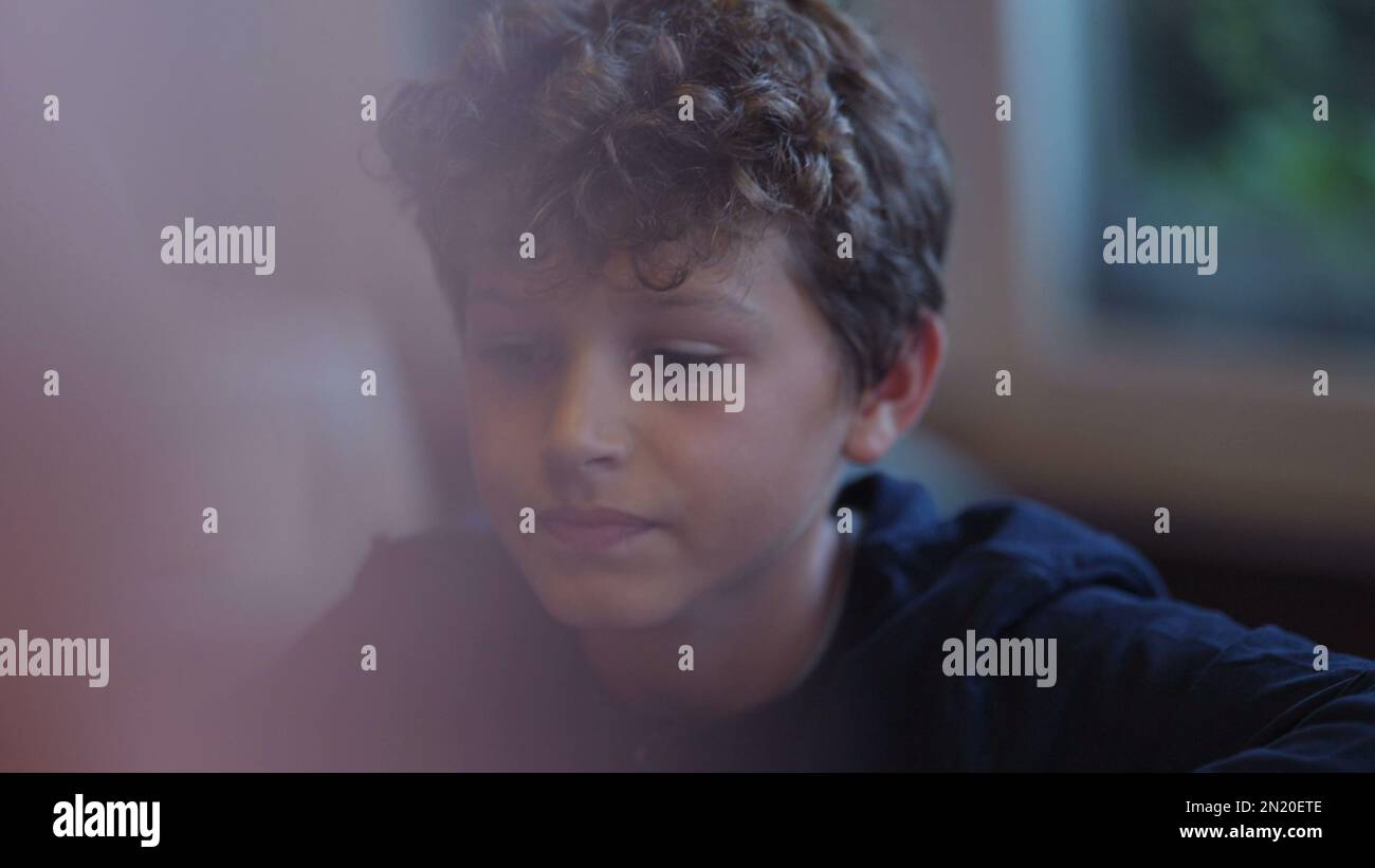 Pensive young boy portrait contemplative child face closeup Stock Photo ...