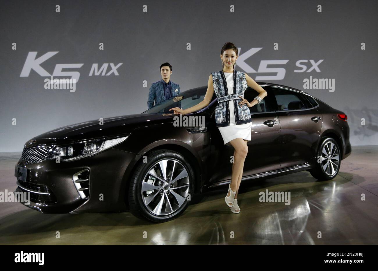 Models pose with Kia Motors' newly-launched K5 sedan during an ...