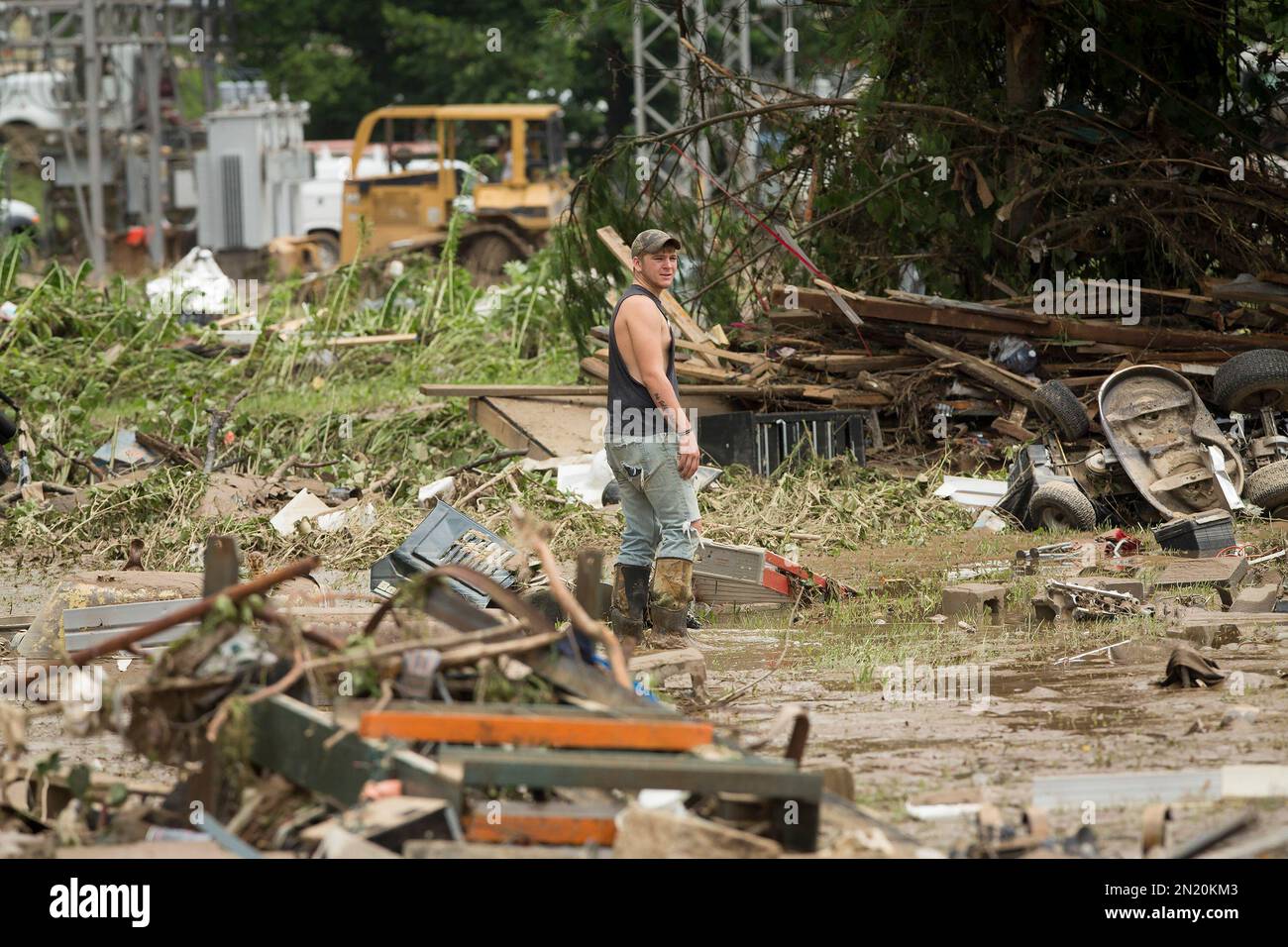 Paxton Reed searches through thick mud and debris for his uncle's 4 ...