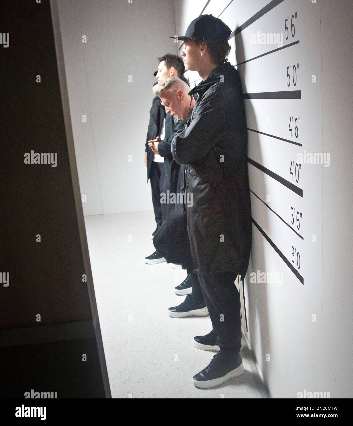 Fashion from Public School is modeled in a police line-up themed ...