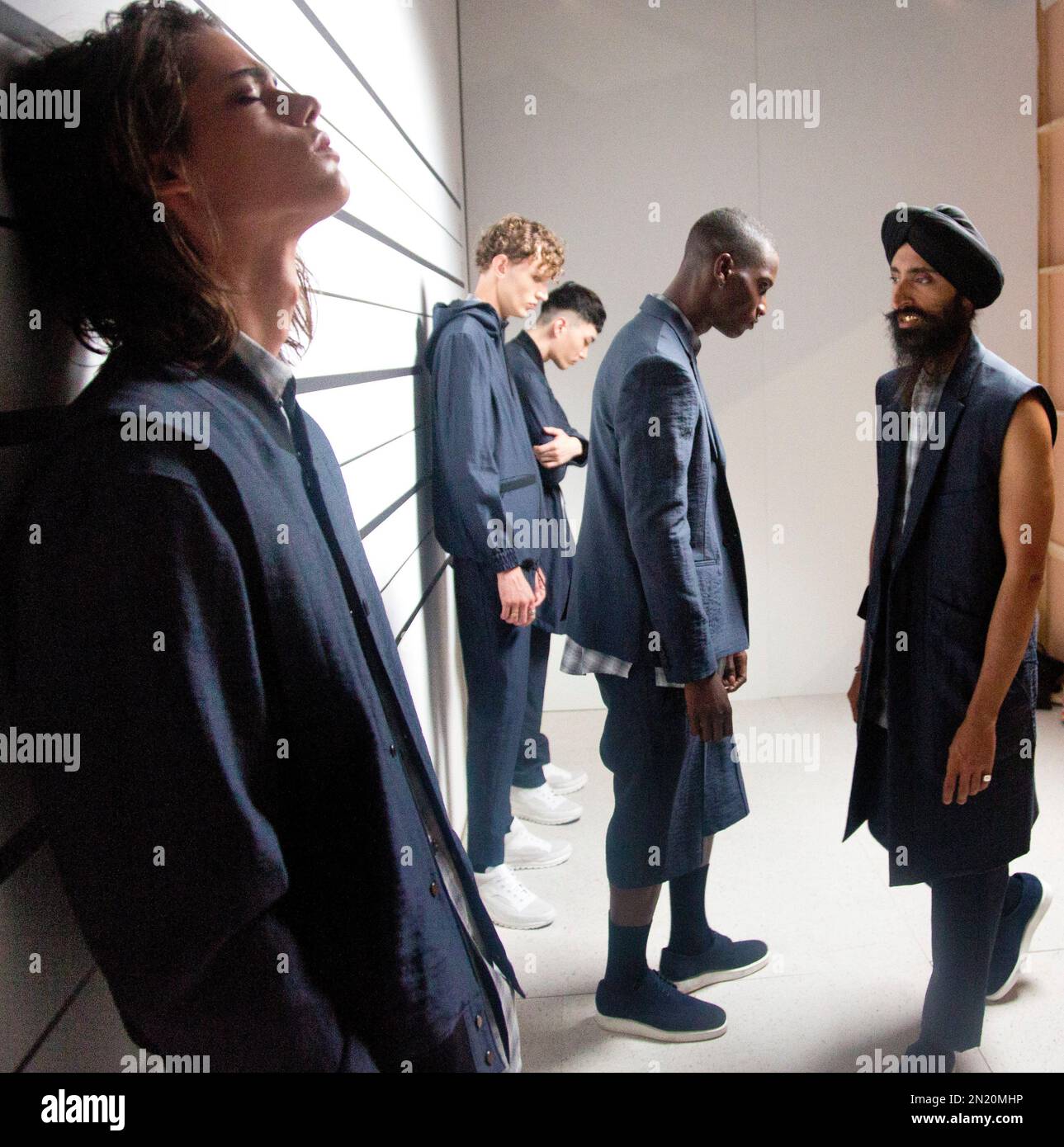 Fashion from Public School is modeled in a police line-up themed ...