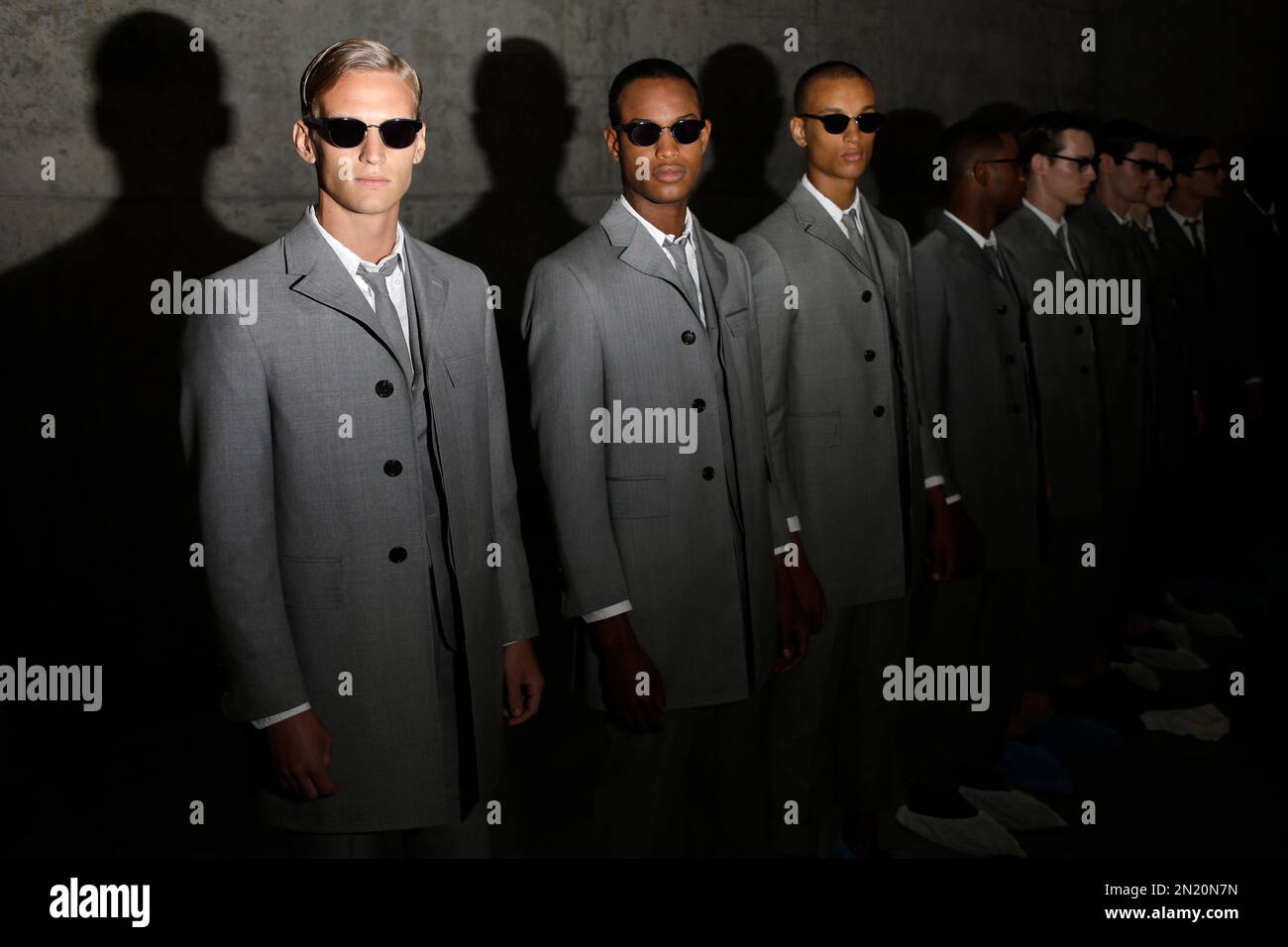 Models line-up to enter a mirrored room for a presentation by Thom ...