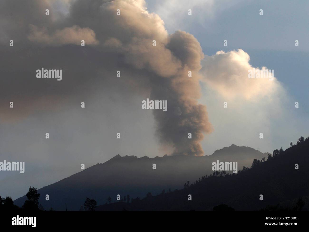 Mount Raung spews volcanic materials into the air as seen from Melaten ...