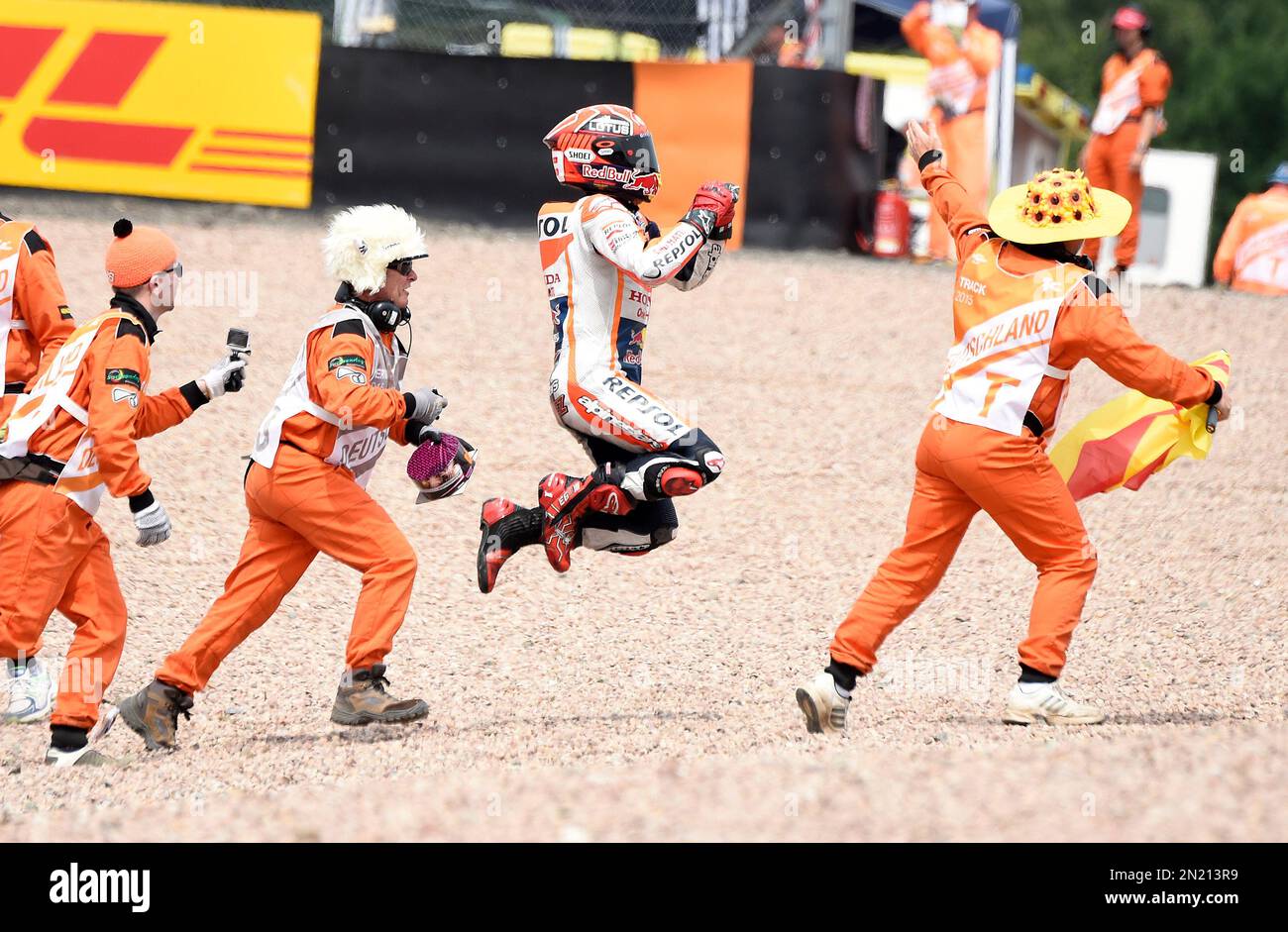 Spain’s Marc Marquez celebrates with track marshals after winning the ...