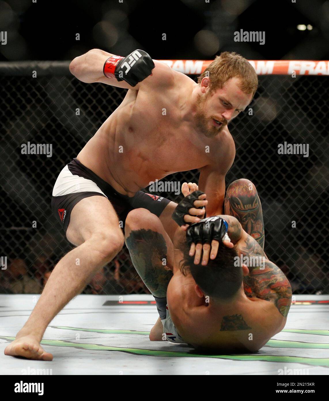 Gunnar Nelson, top, wrestles with Brandon Thatch during their ...