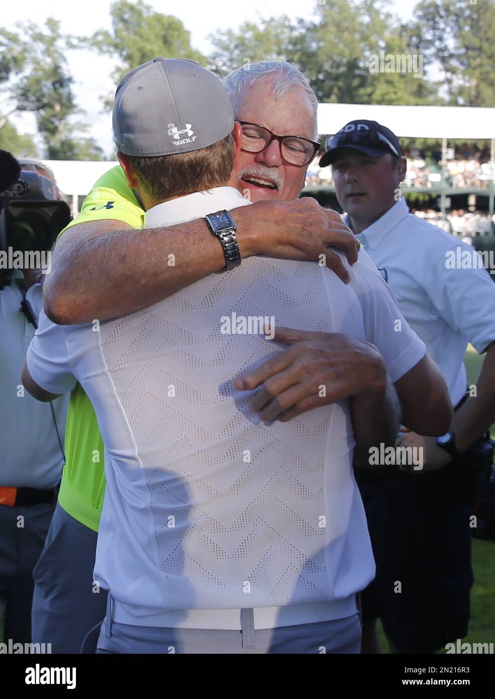 Jordan Spieth, back to camera, hugs his grandfather Bob Julius after finishing the third round ...