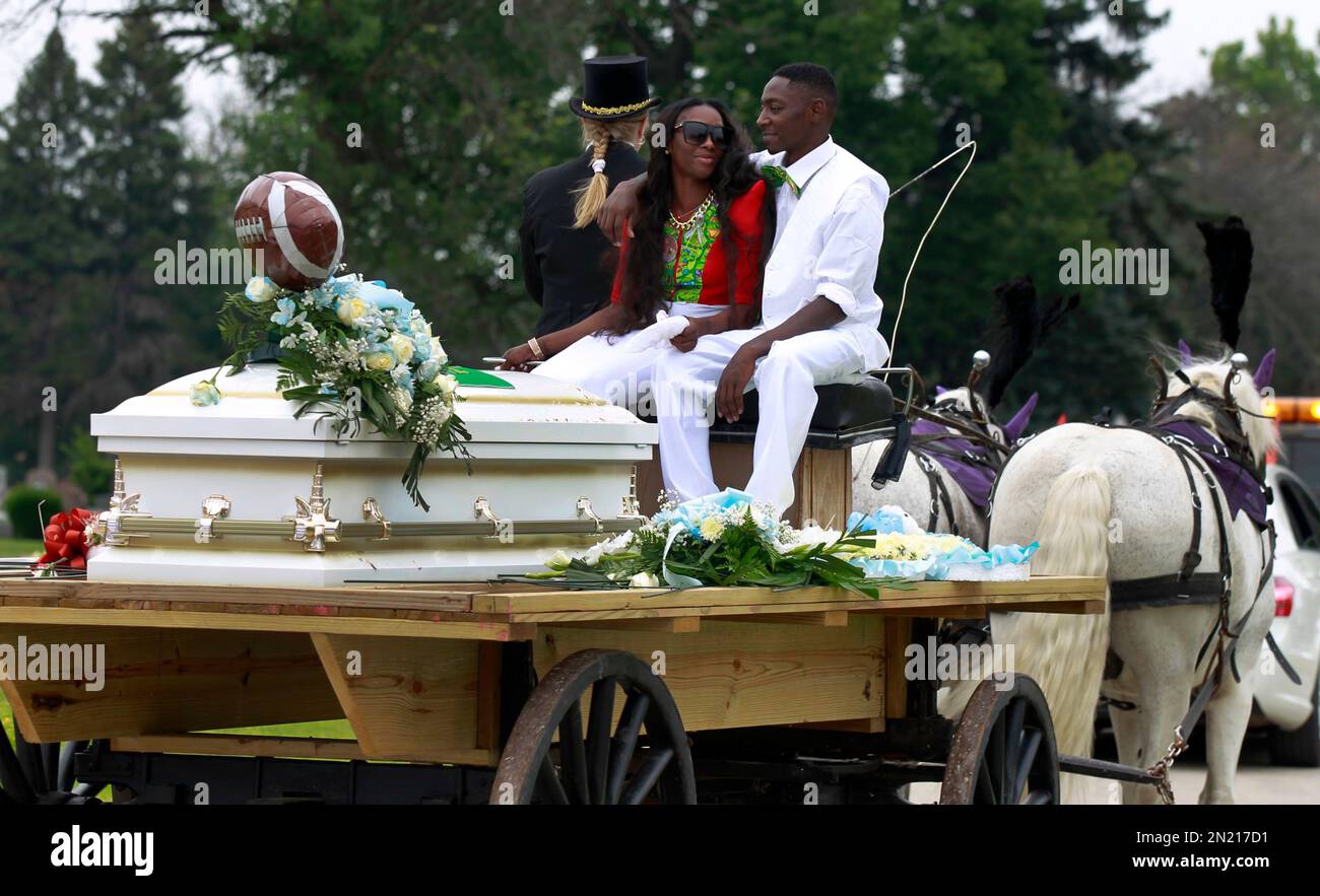 Antonio Brown and Amber Hailey accompany the casket of their 7-year-old ...