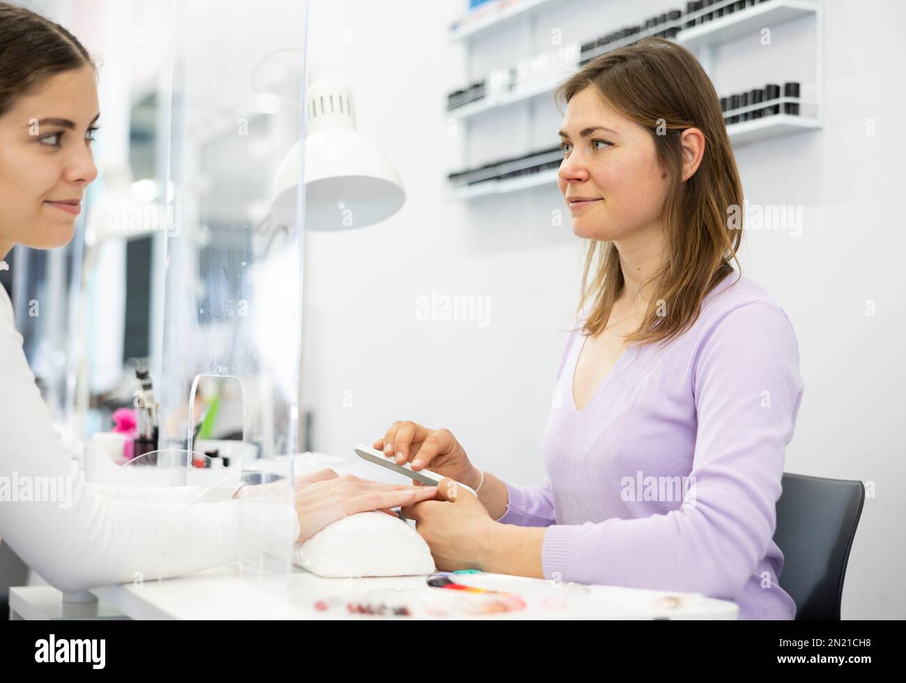 Woman nail buffing hi-res stock photography and images - Alamy