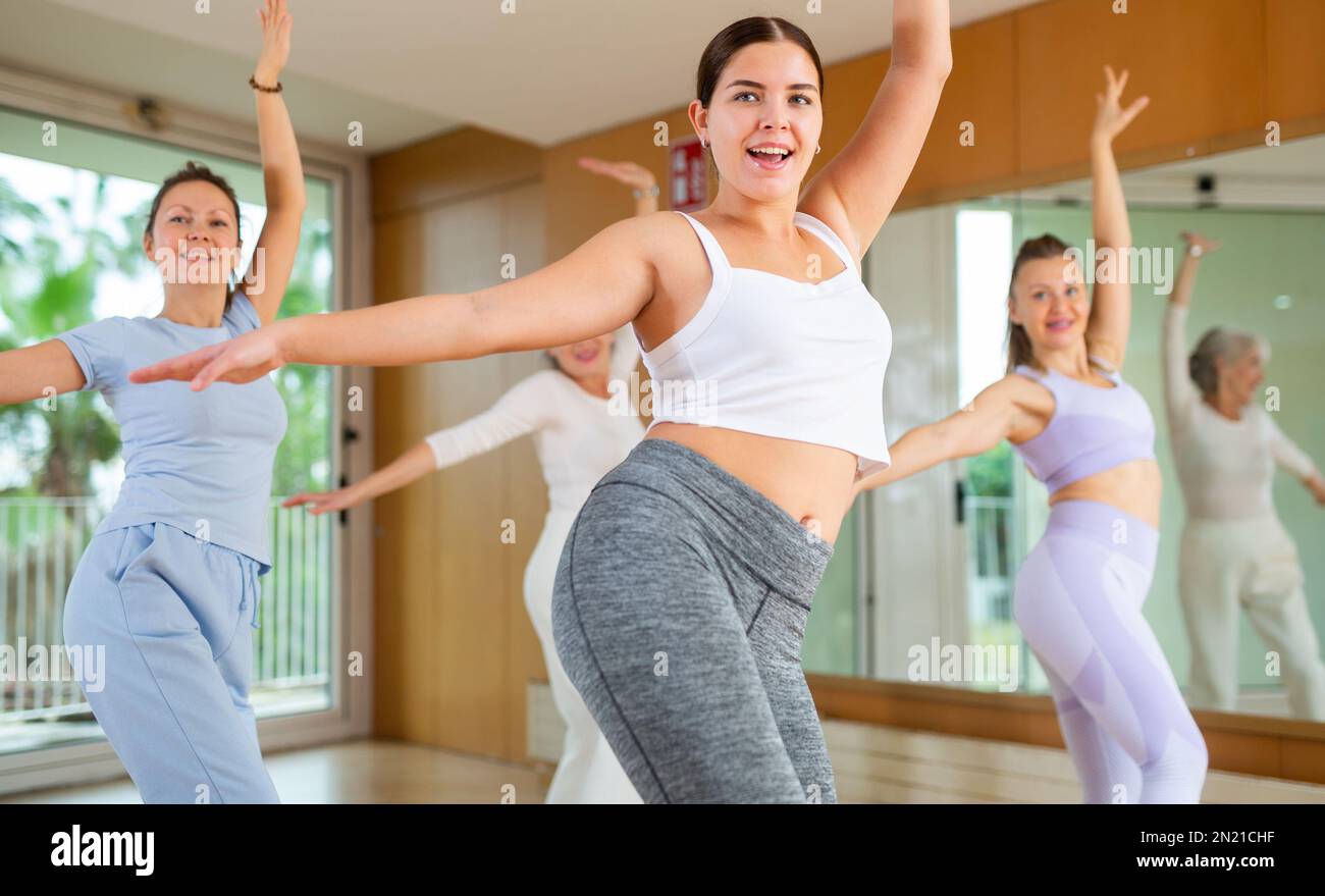 Group are practising arch movement in step jazz dance in fitness gym ...