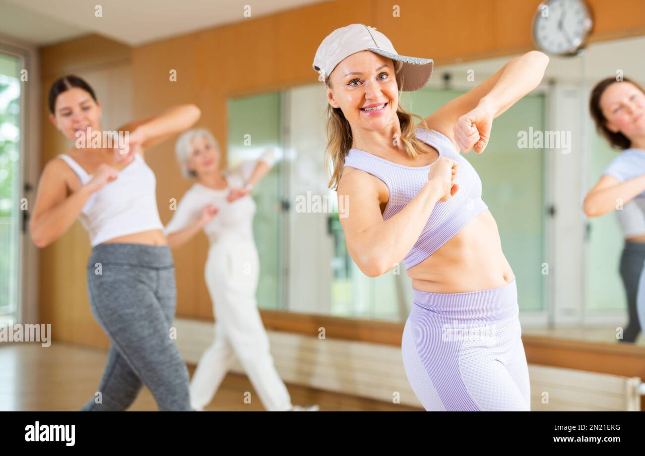 Group are practising arch movement in step jazz dance in fitness gym ...