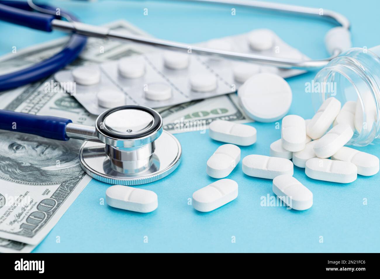 Healthcare cost concept. US Dollars bills, stethoscope and medicine ...
