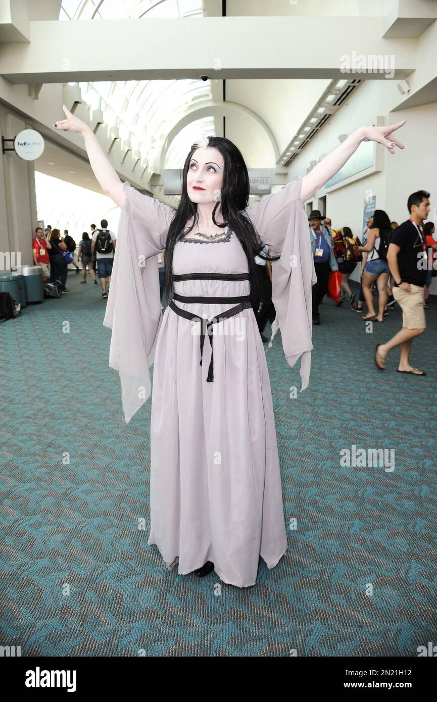 A costumed character poses for photographs on day one of Comic-Con 2015 ...